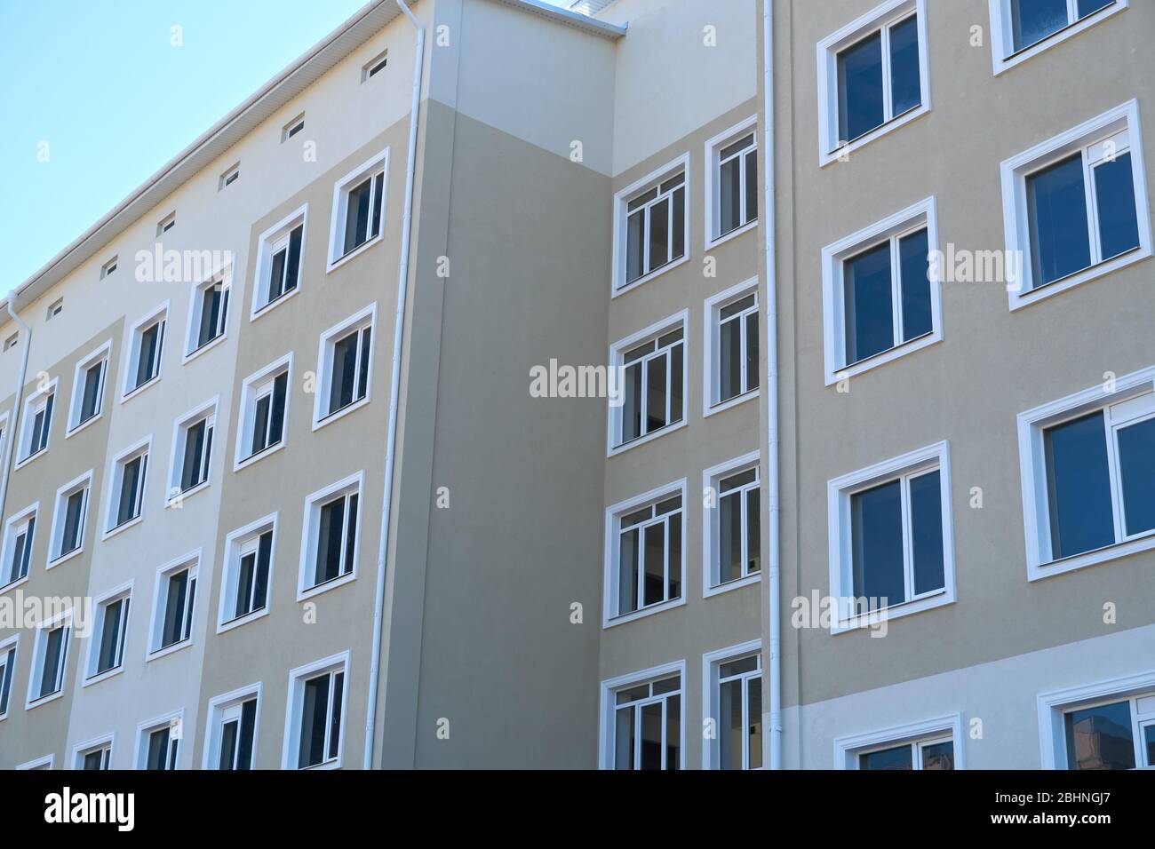 facade of a new multi-storey building with many windows Stock Photo - Alamy
