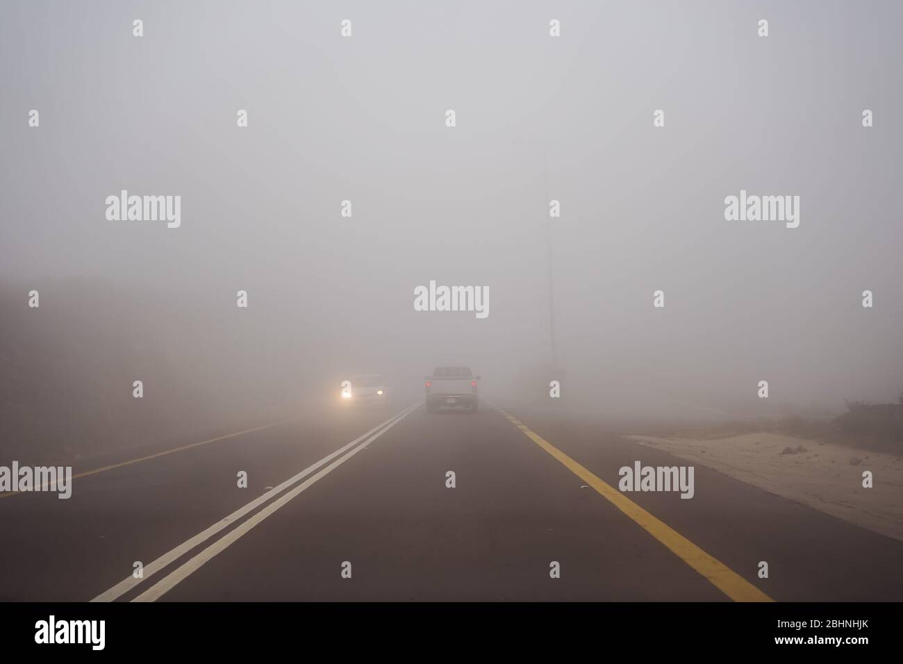 Car and truck driving in dense fog in the mountains near Abha, Saudi ...