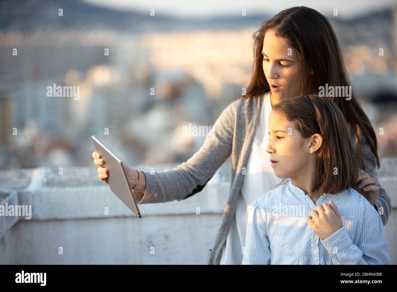 Two girls watching multimedia content using a tablet Stock Photo - Alamy