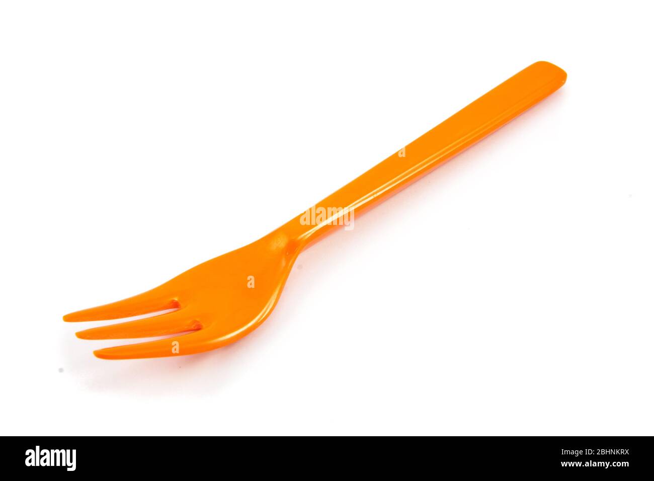 Orange plastic forks isolated on white background Stock Photo - Alamy