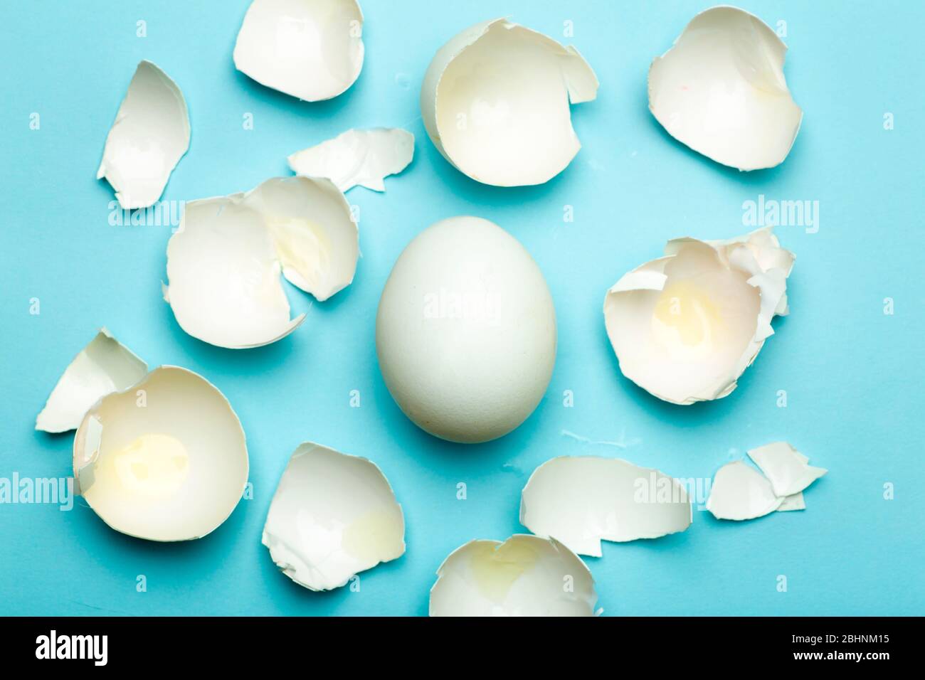 Egg and eggshell on a colored empty background. Minimal food concept ...