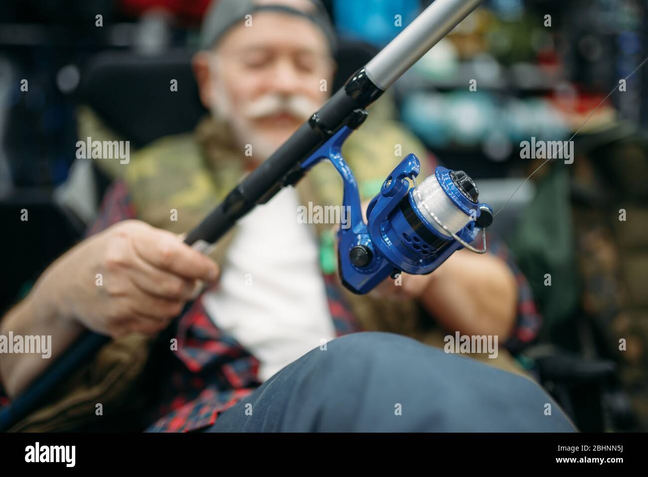 Man sitting in chair fishing hi-res stock photography and images - Alamy
