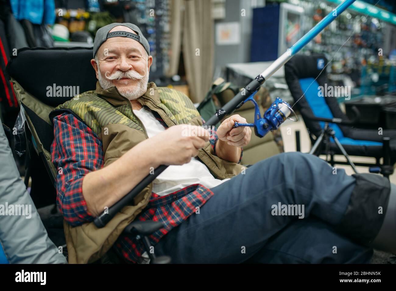 Man sitting in chair fishing hi-res stock photography and images - Alamy