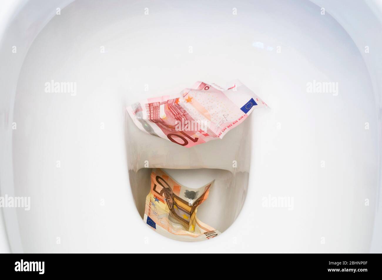 Euro bills in the toilet Stock Photo - Alamy