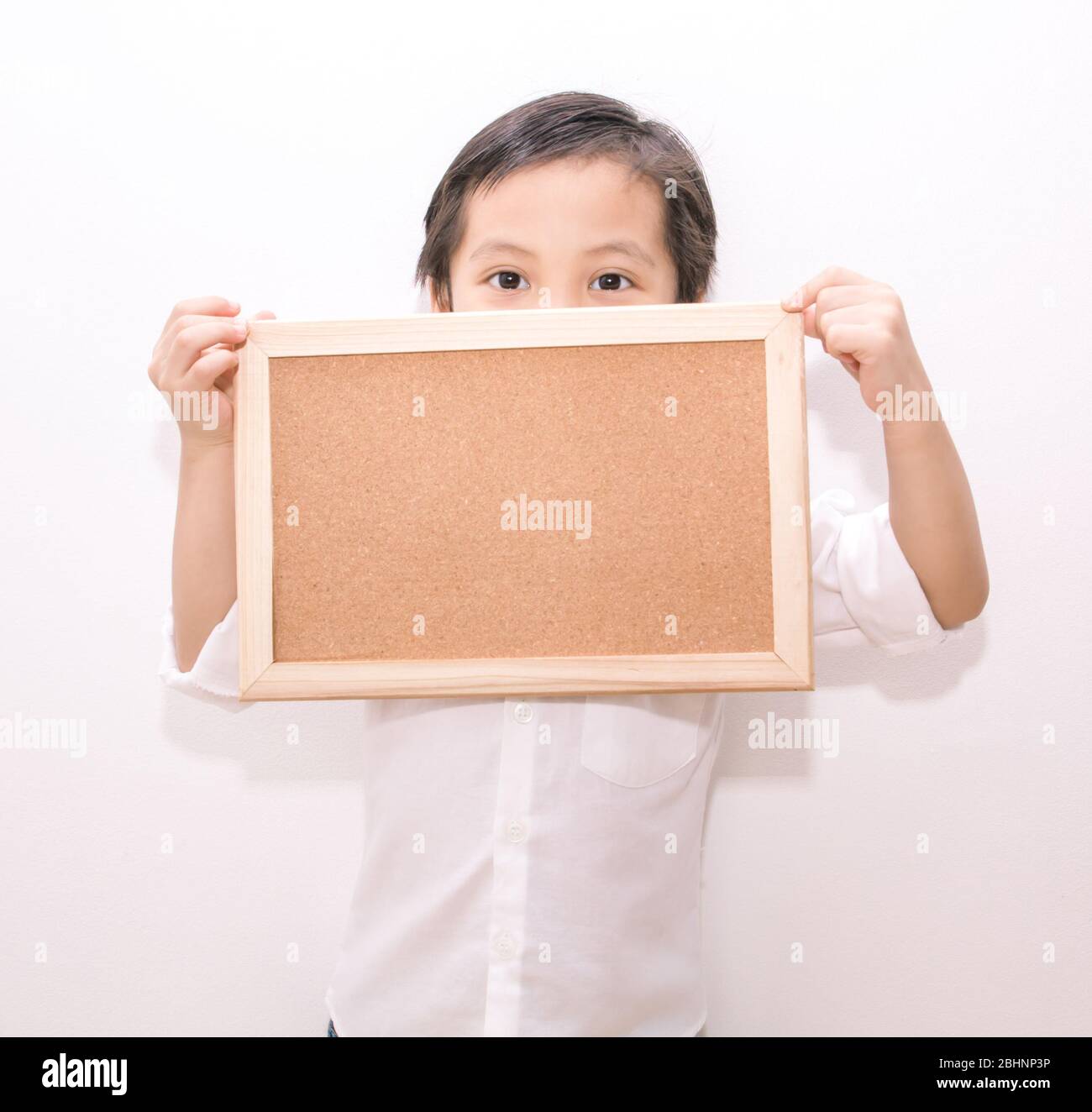 portrait of a little boy holding a board Stock Photo - Alamy