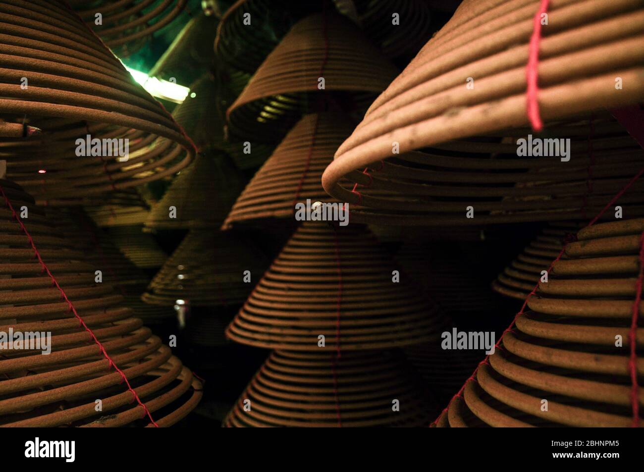 Temple interior Large spiral incense cones hanging from roof Stock ...