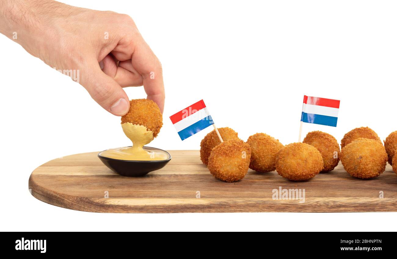 Dutch traditional snack bitterbal in a hand, isolated Stock Photo - Alamy
