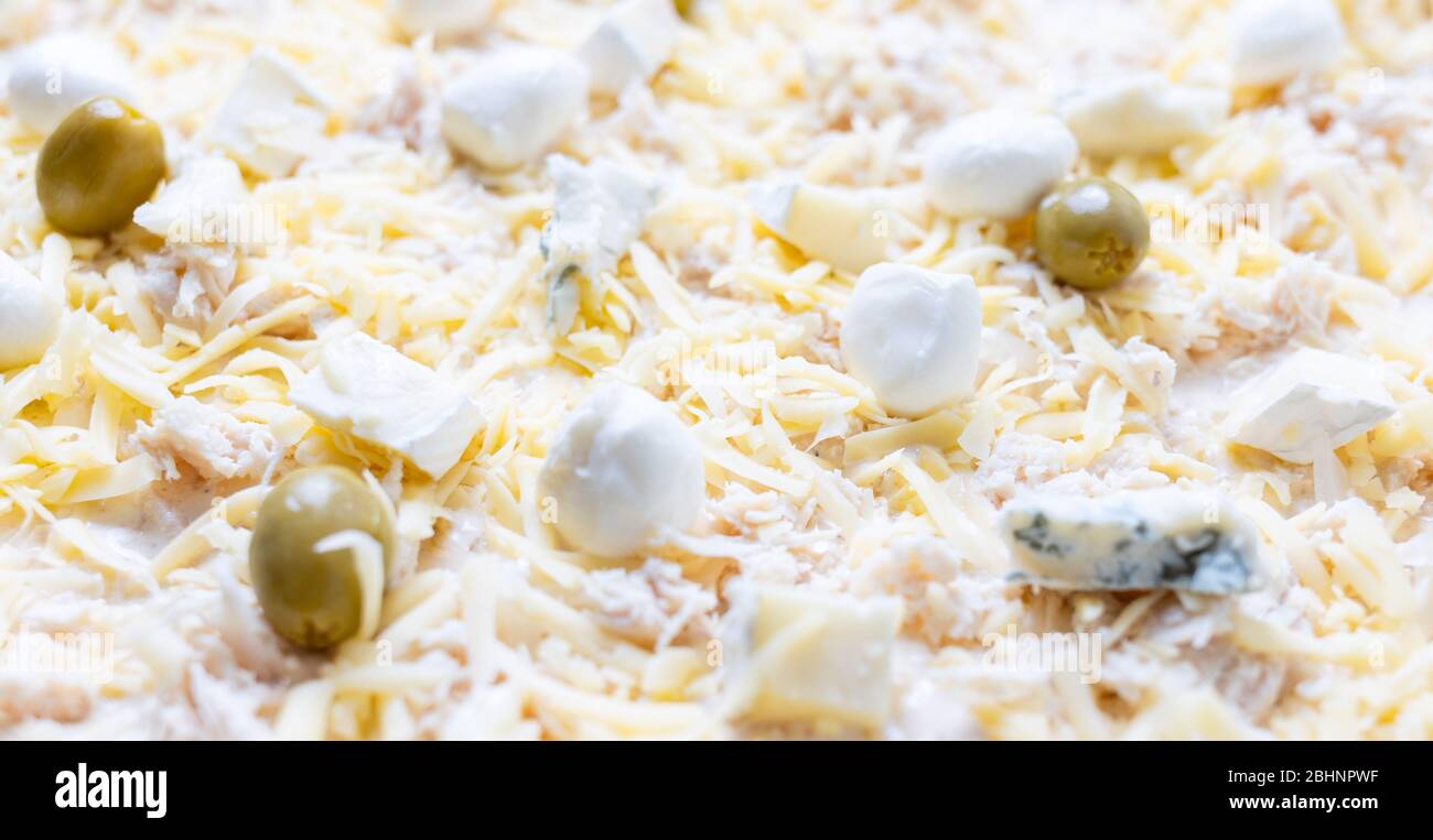 Close up image of raw four cheese pizza or quattro formaggi ready for baking Stock Photo - Alamy