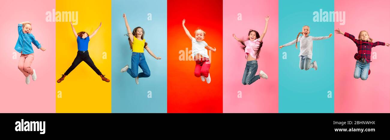 Emotional kids and teens jumping high, look happy, cheerful on ...