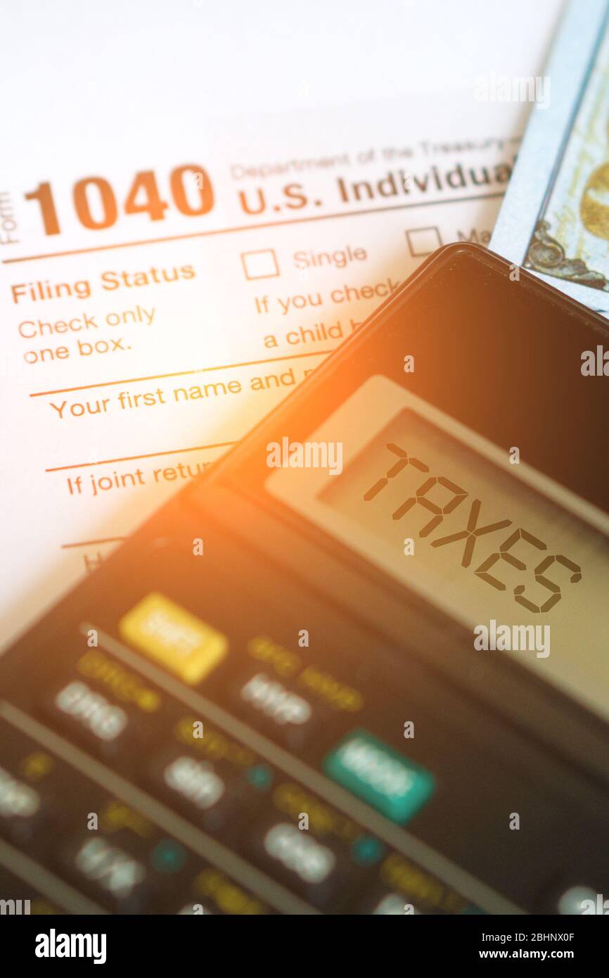 Business and tax concept. Tax form 1040, pen and calculator on the desk ...
