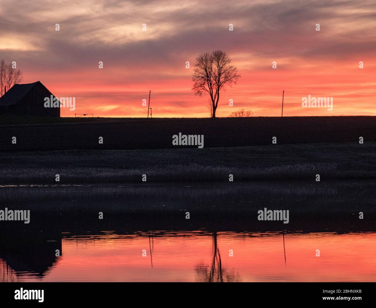 beautiful sunset by the lake, bright colors, sky reflections in the ...