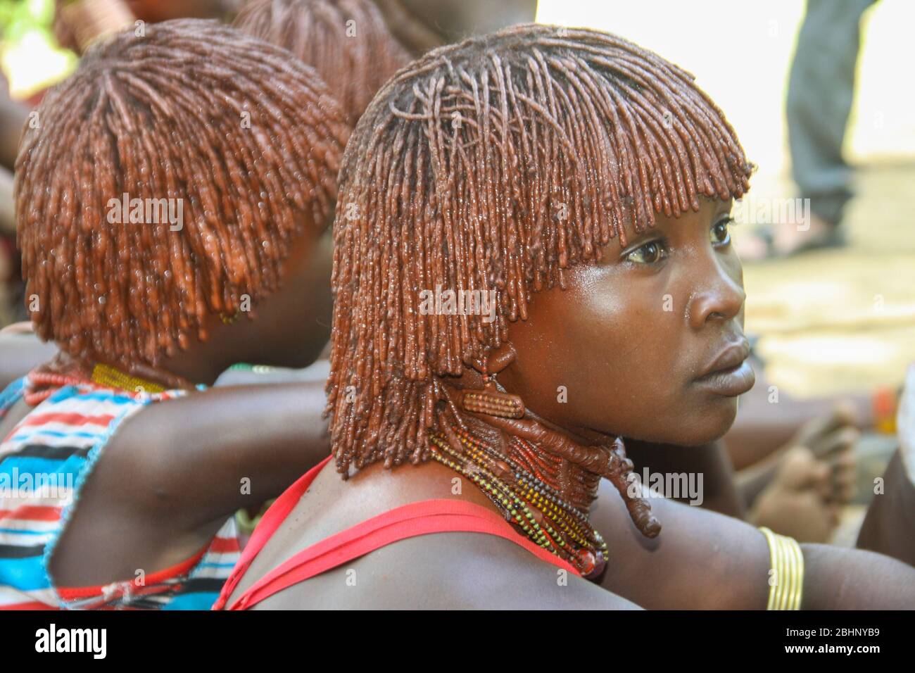 Portrait of a Hamer Tribeswoman. The hair is coated with ochre mud and ...