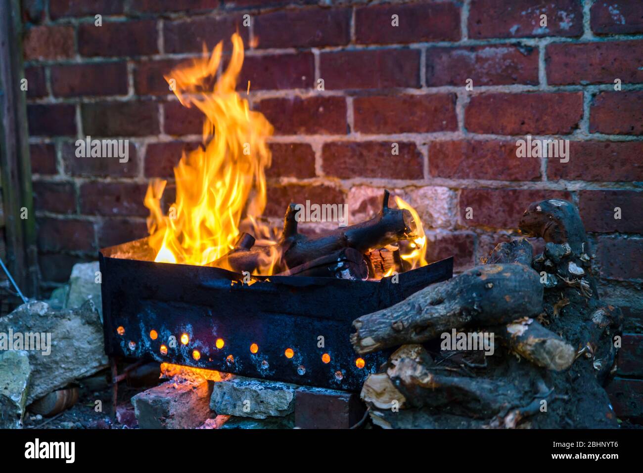 fire and grill over red brick wall background in backyard Stock Photo ...