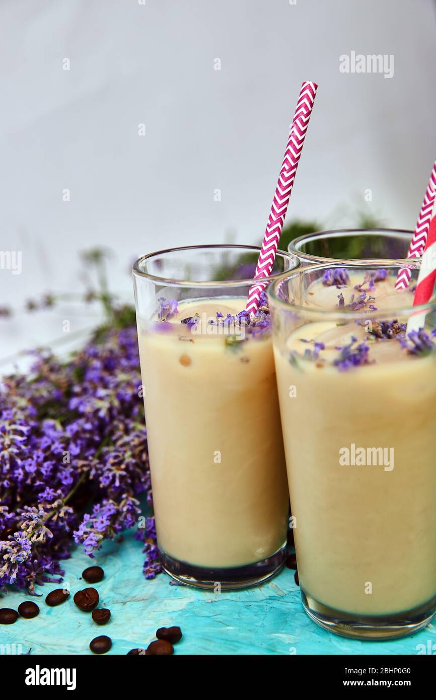 Summer drink iced coffee with lavender in glass and coffee beans on ...