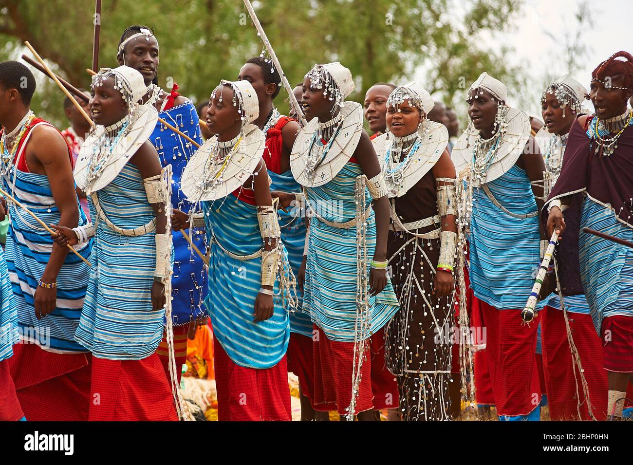 A Maasai choir dressed in traditional clothes and wearing their ...