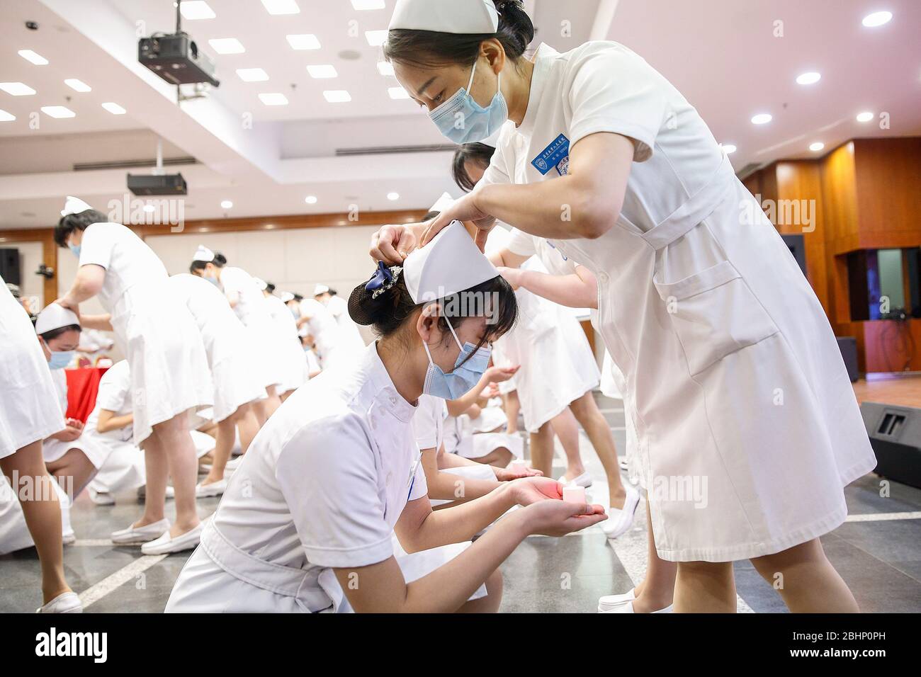 Beijing, China. 26th Apr, 2020. Newly recruited nurses attend a capping ...