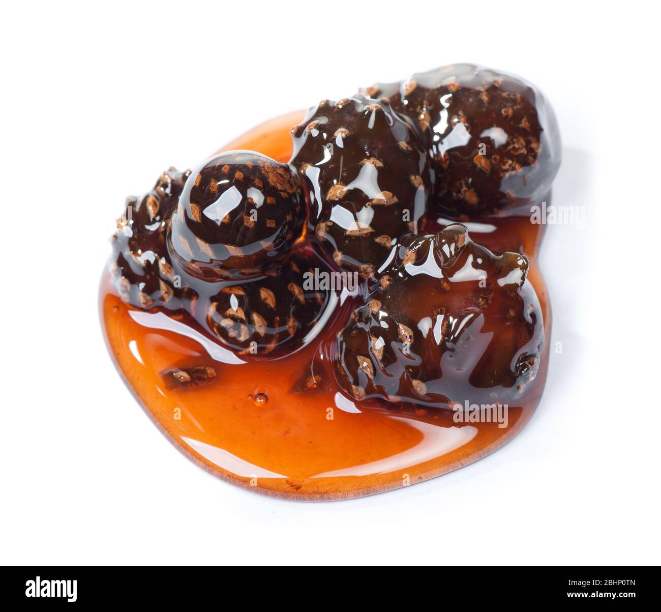 Spill of pine cone jam isolated on white background Stock Photo - Alamy