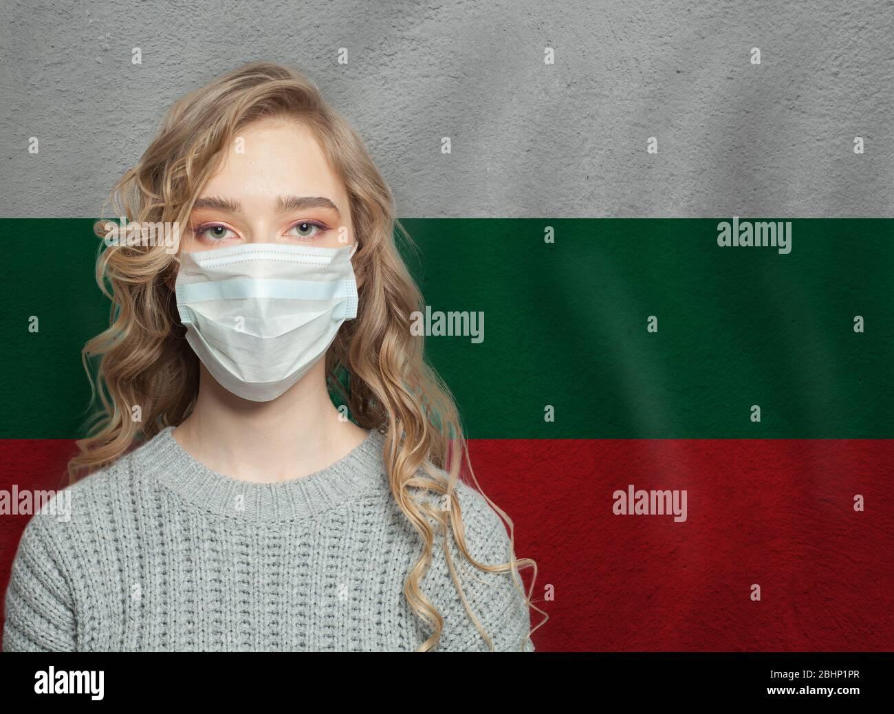 Young woman wearing a face mask with national flag Bulgaria. Flu ...