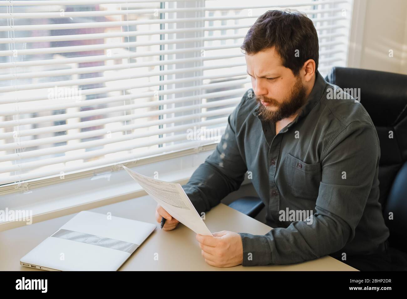 Engineer working with documents at office, closed laptop on desk Stock ...