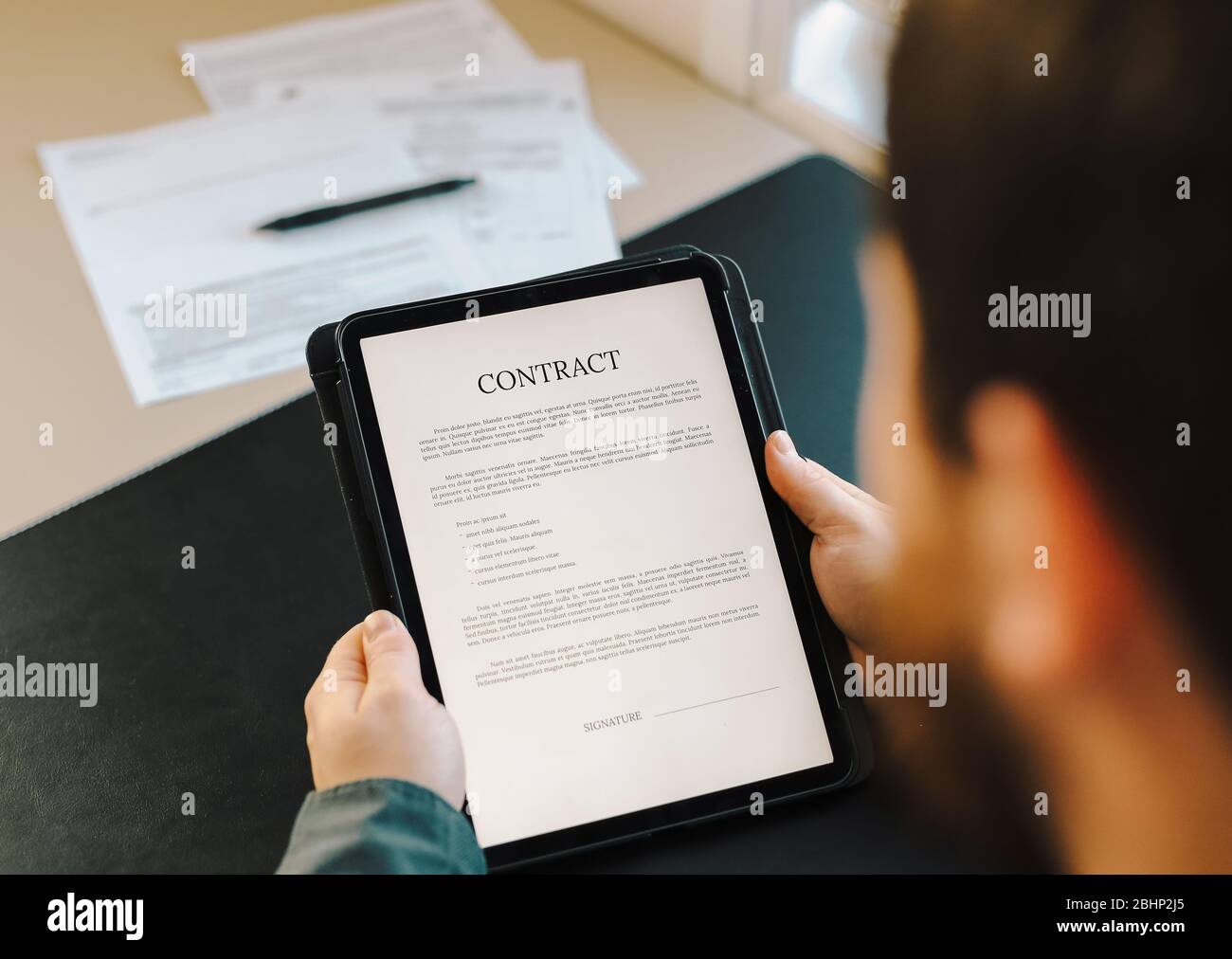 Businessman showing contract template on tablet Stock Photo - Alamy
