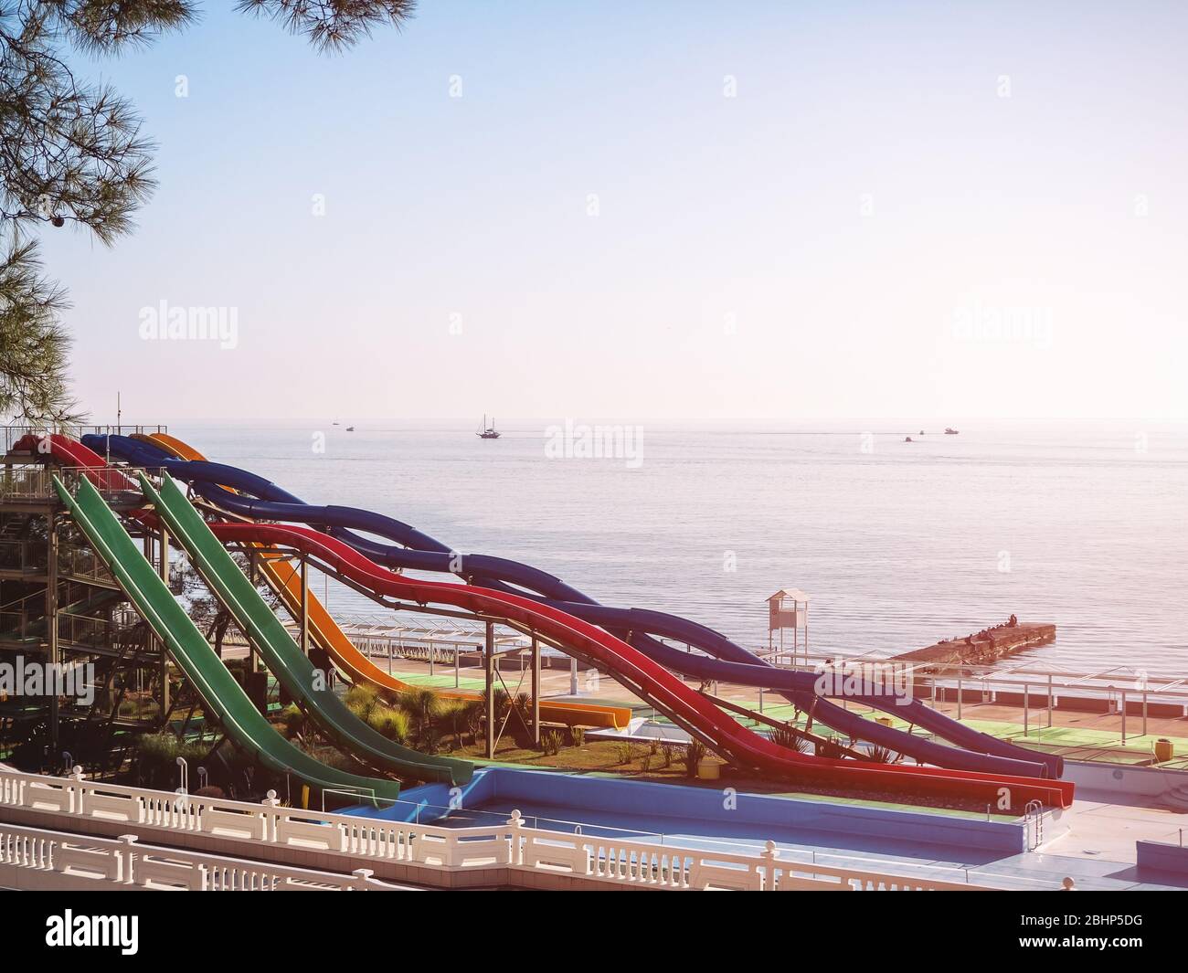 Colored slides in a water park on the background of the sea Stock Photo ...