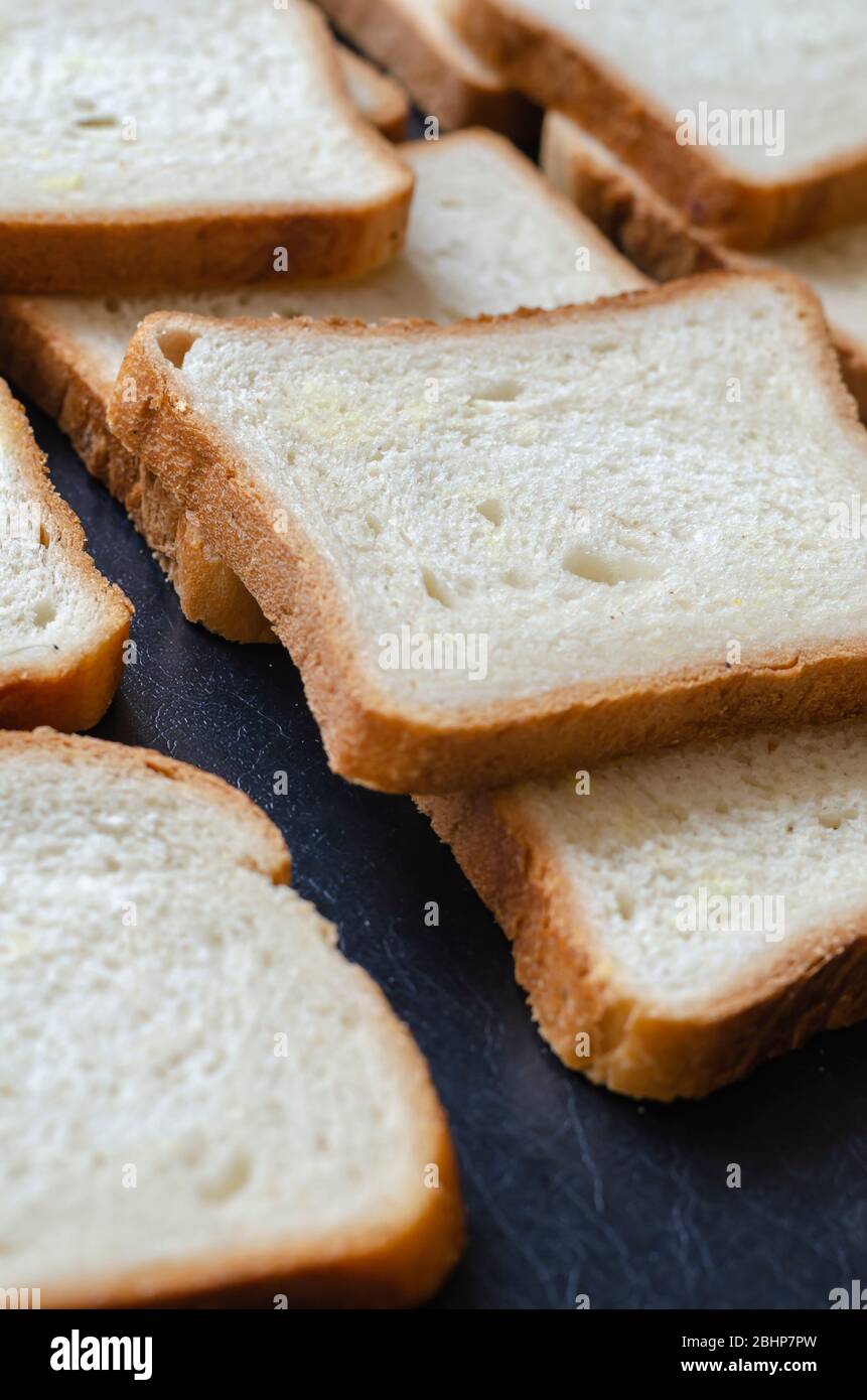 Sandwich bread background. Rectangular pieces of bread pile on the ...