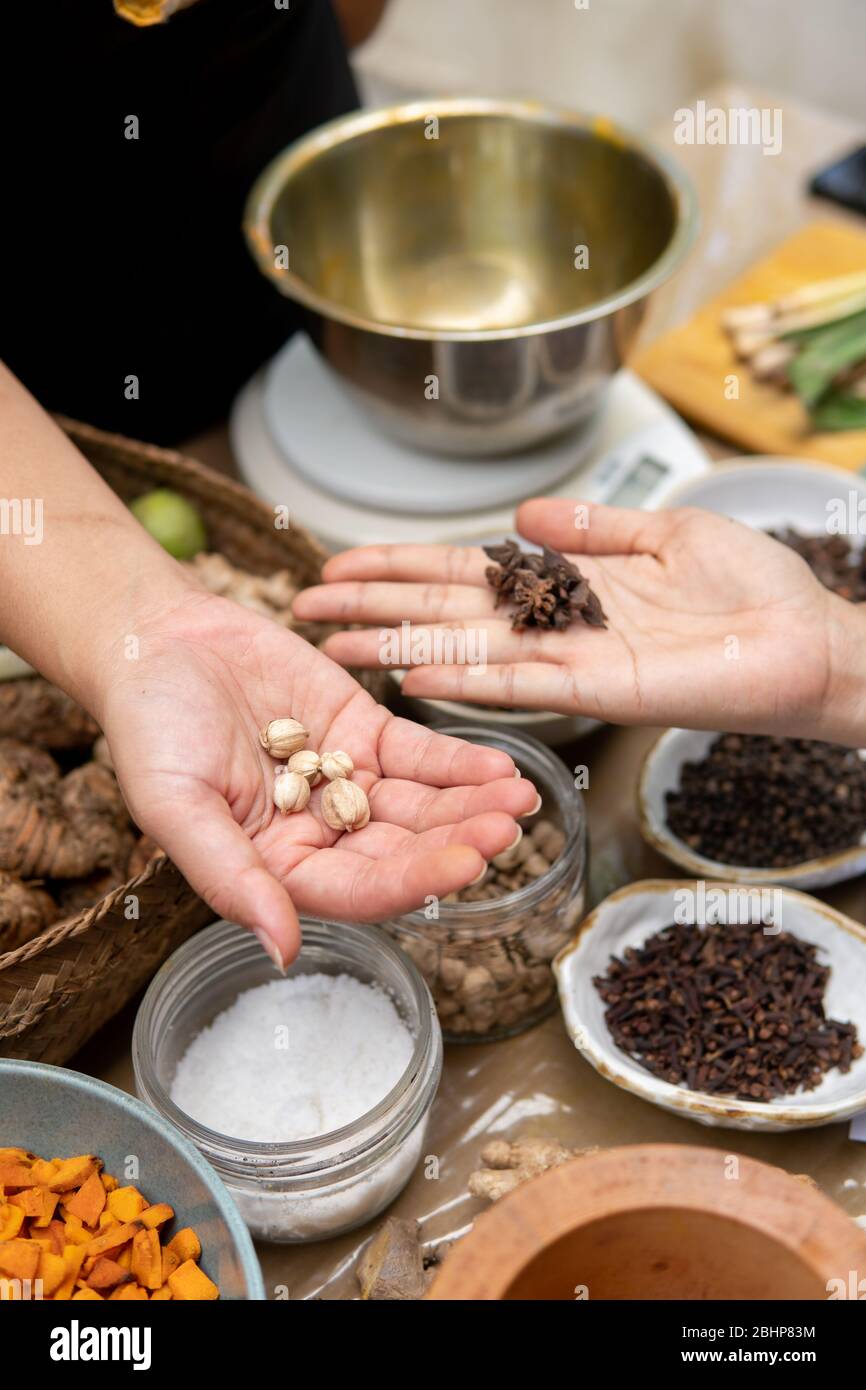 hand holding cardamom and traditional spice ingredient for jamu herbal ...