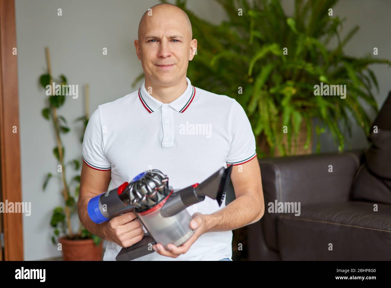 Adult male using vacuum cleaner High Resolution Stock Photography and ...