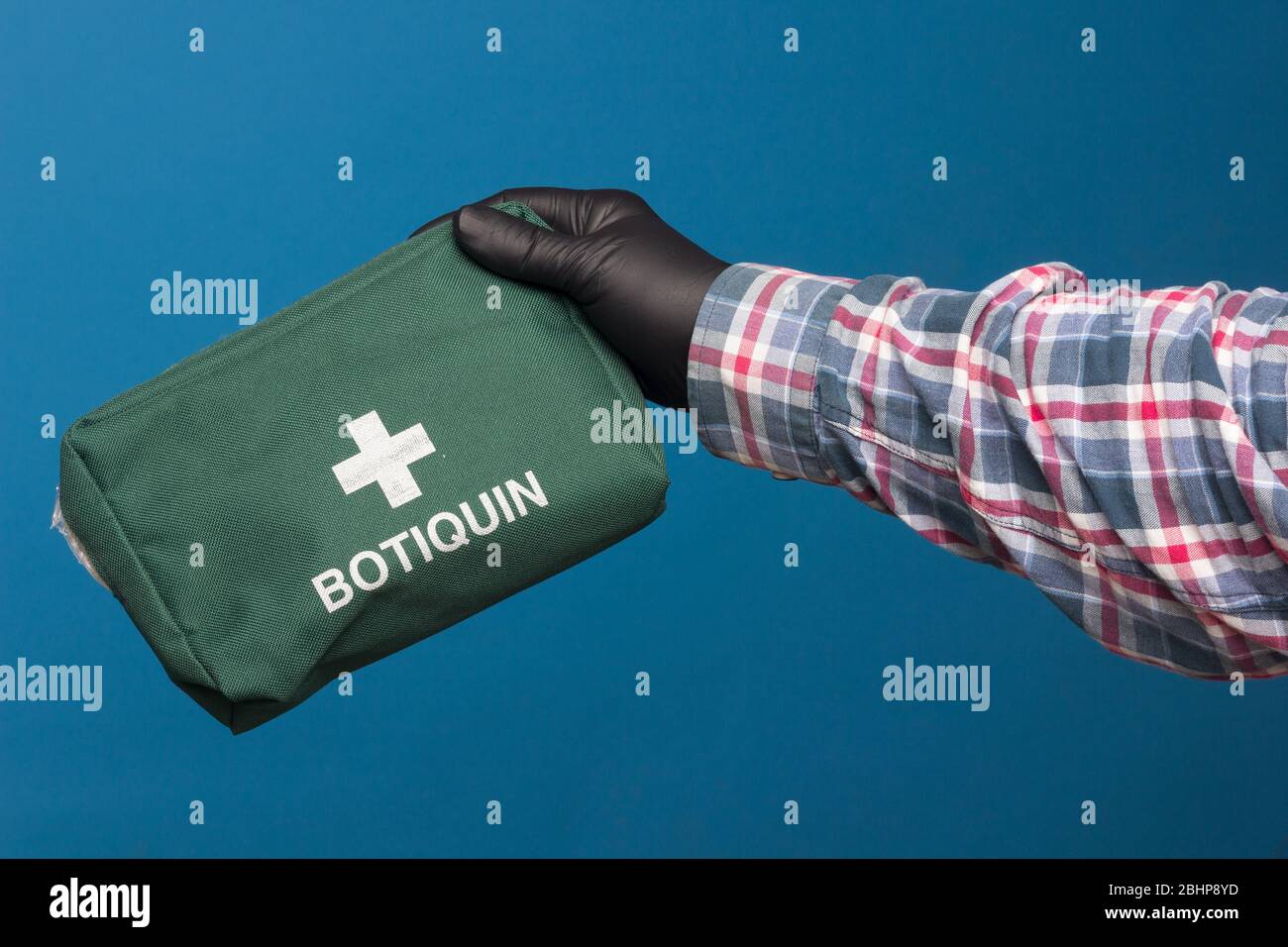Green fabric medicine cabinet in hand with black hygienic glove. First ...
