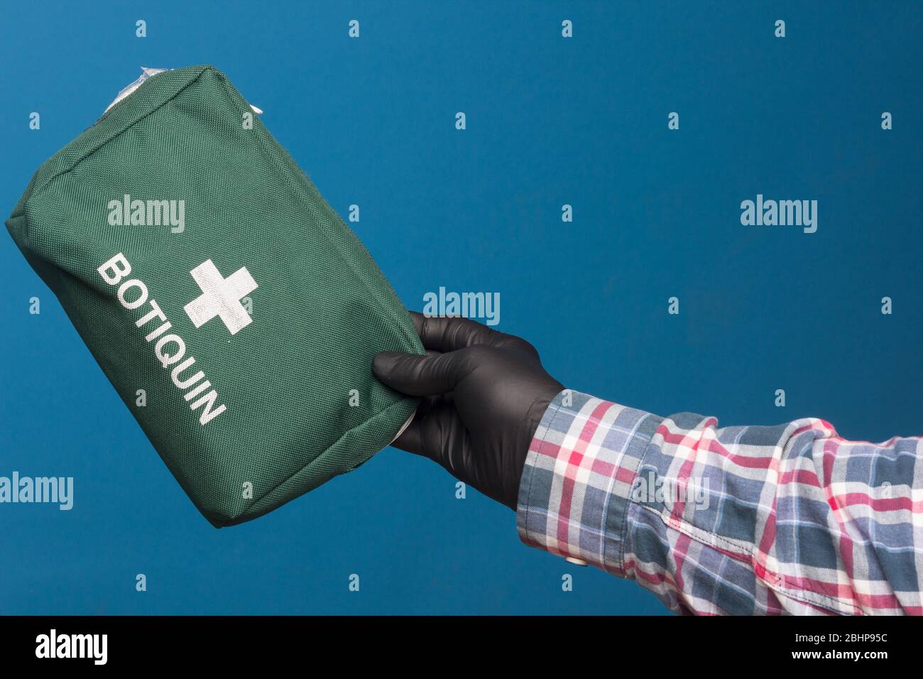 Green fabric medicine cabinet in hand with black hygienic glove. First ...
