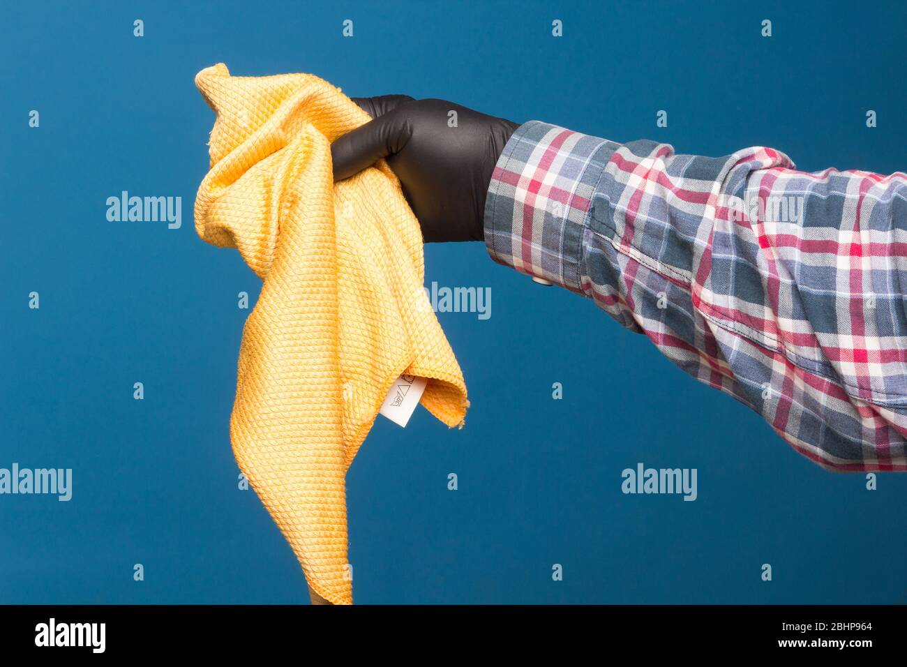 Cleaning material in hand with a hygienic protective glove to disinfect ...