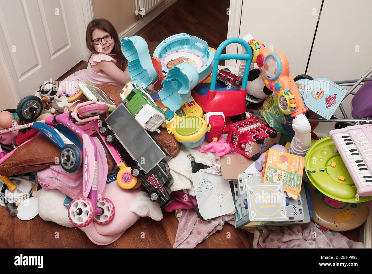Child surrounded by plastic toys hi-res stock photography and images - Alamy