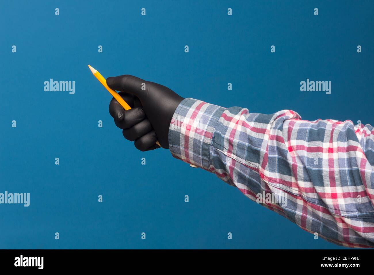 Color pencil with black hygienic protection glove on blue background ...