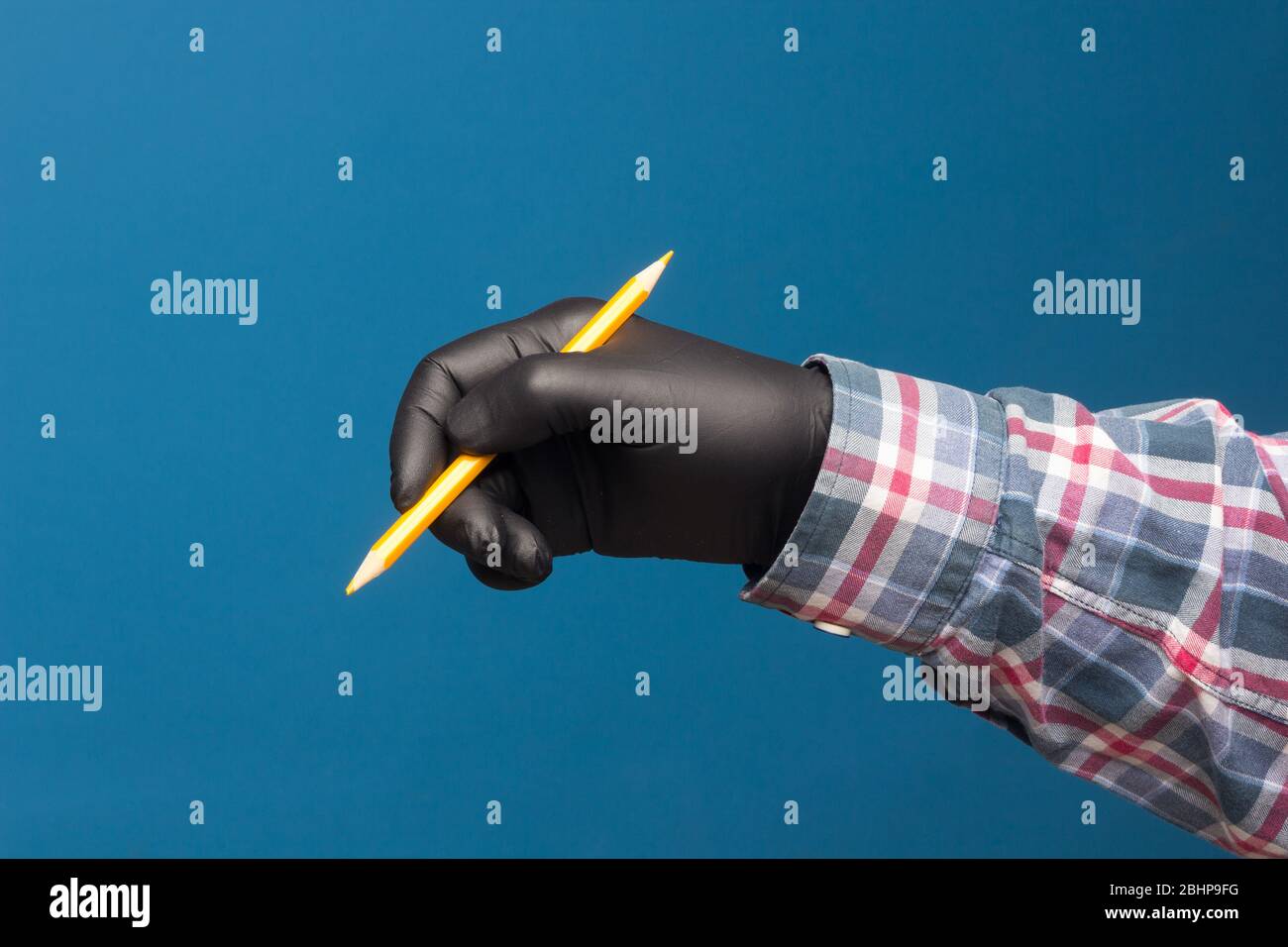 Color pencil with black hygienic protection glove on blue background ...