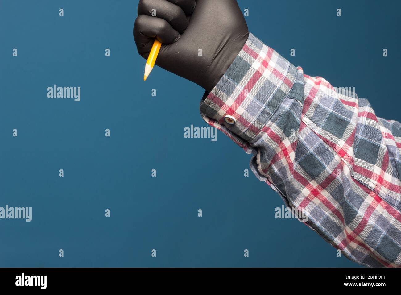 Color pencil with black hygienic protection glove on blue background ...