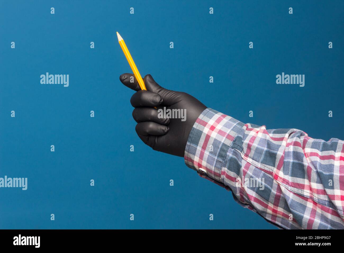 Color pencil with black hygienic protection glove on blue background ...
