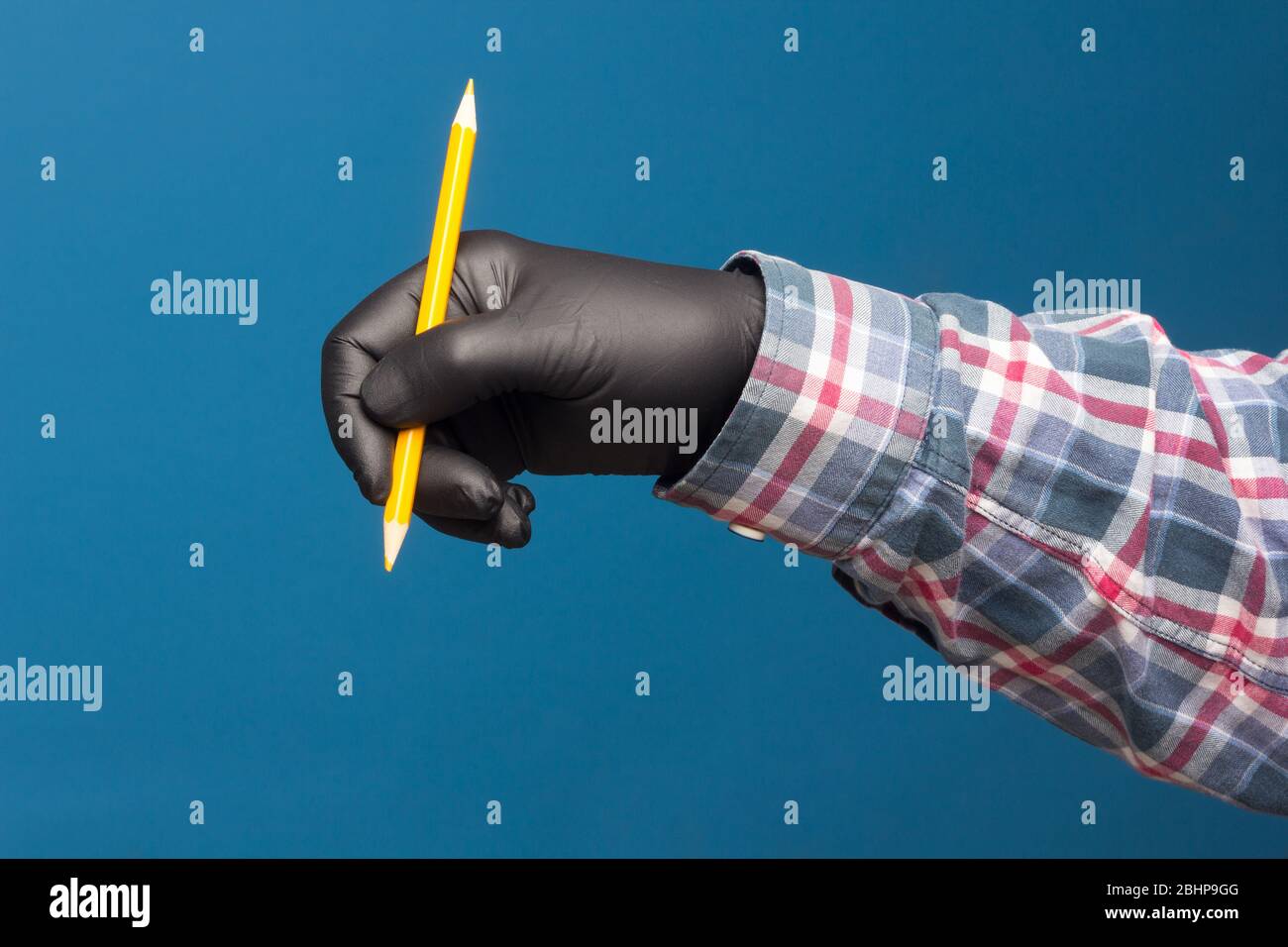 Color pencil with black hygienic protection glove on blue background ...