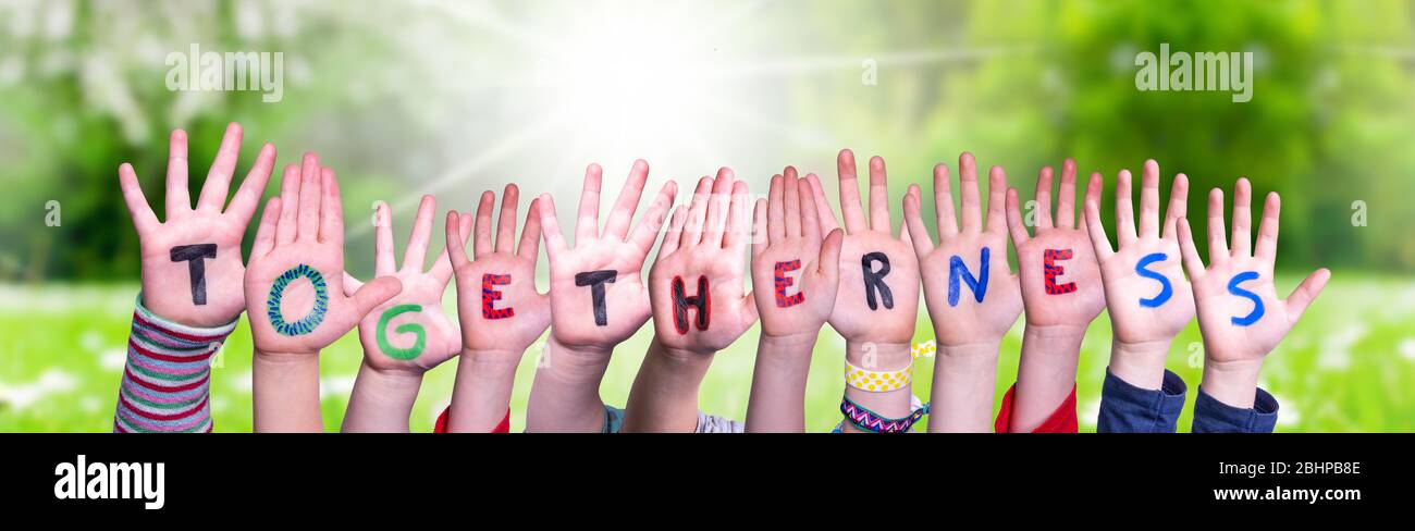 Children Hands Building Word Togetherness, Grass Meadow Stock Photo - Alamy