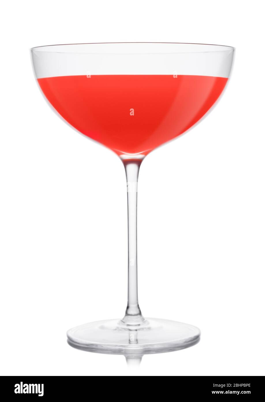 Cosmopolitan cocktail in luxury crystal glass with pink cherry on white ...
