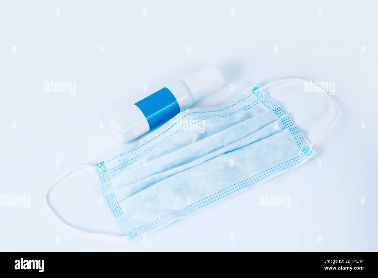 Close up picture of a facial mask and a disinfecting spray Stock Photo ...