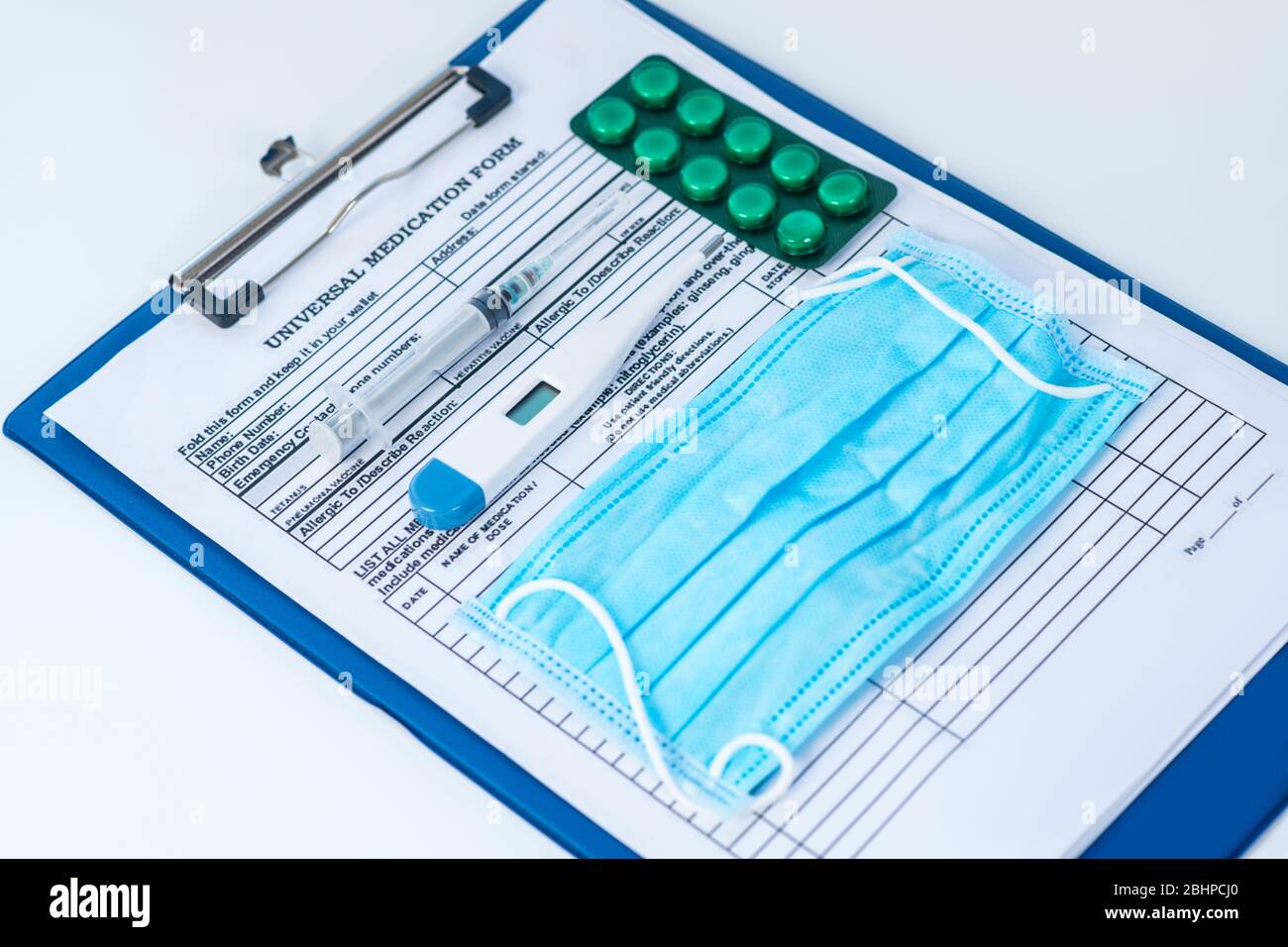 Close up picture of medication form and thermometer, pills and syringe ...