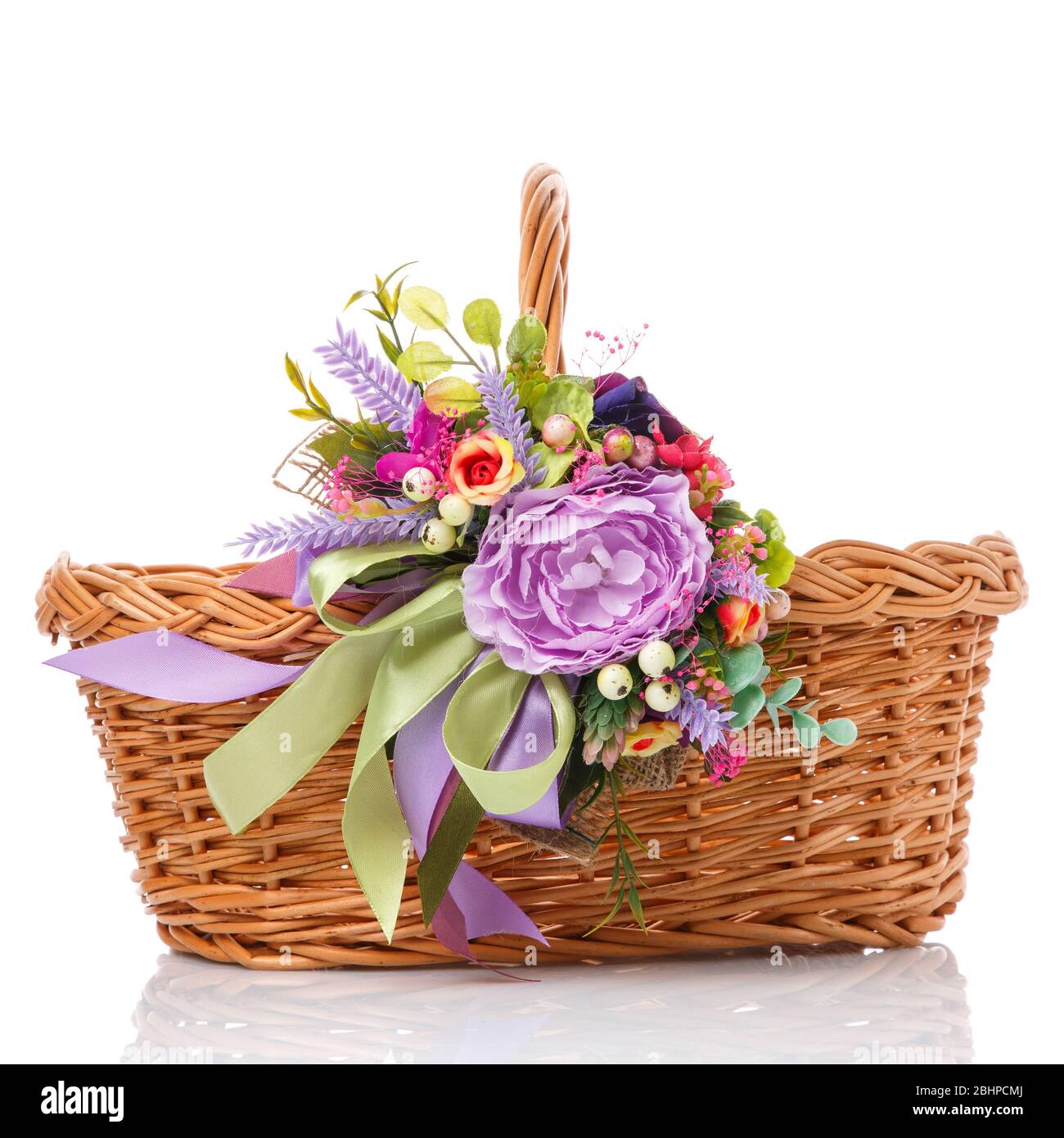 Brown wicker basket decorated with colorful flowers and ribbons ...