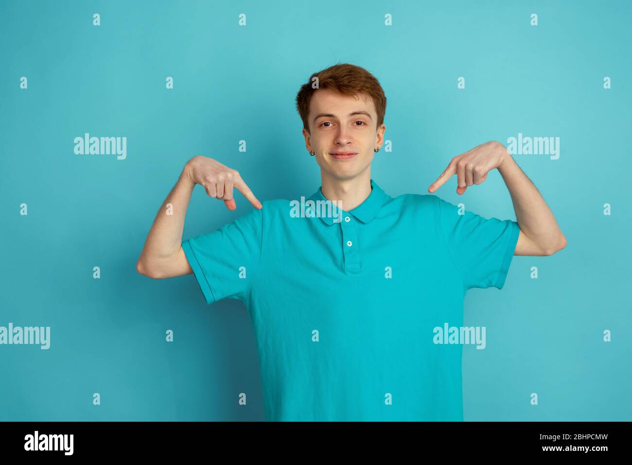 Pointing at himself. Caucasian young man's modern portrait isolated on ...