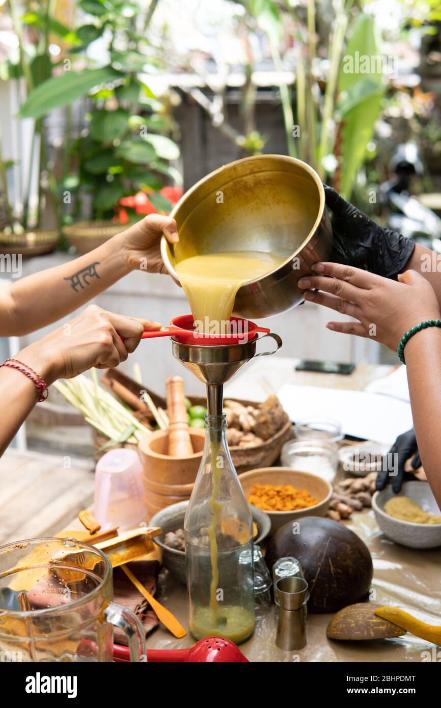 jamu traditional. close up of hand fill in the bottle with indonesian ...