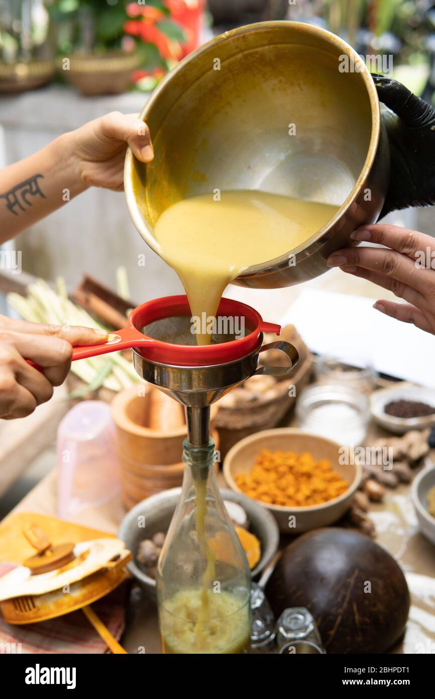 jamu traditional. close up of hand fill in the bottle with indonesian ...