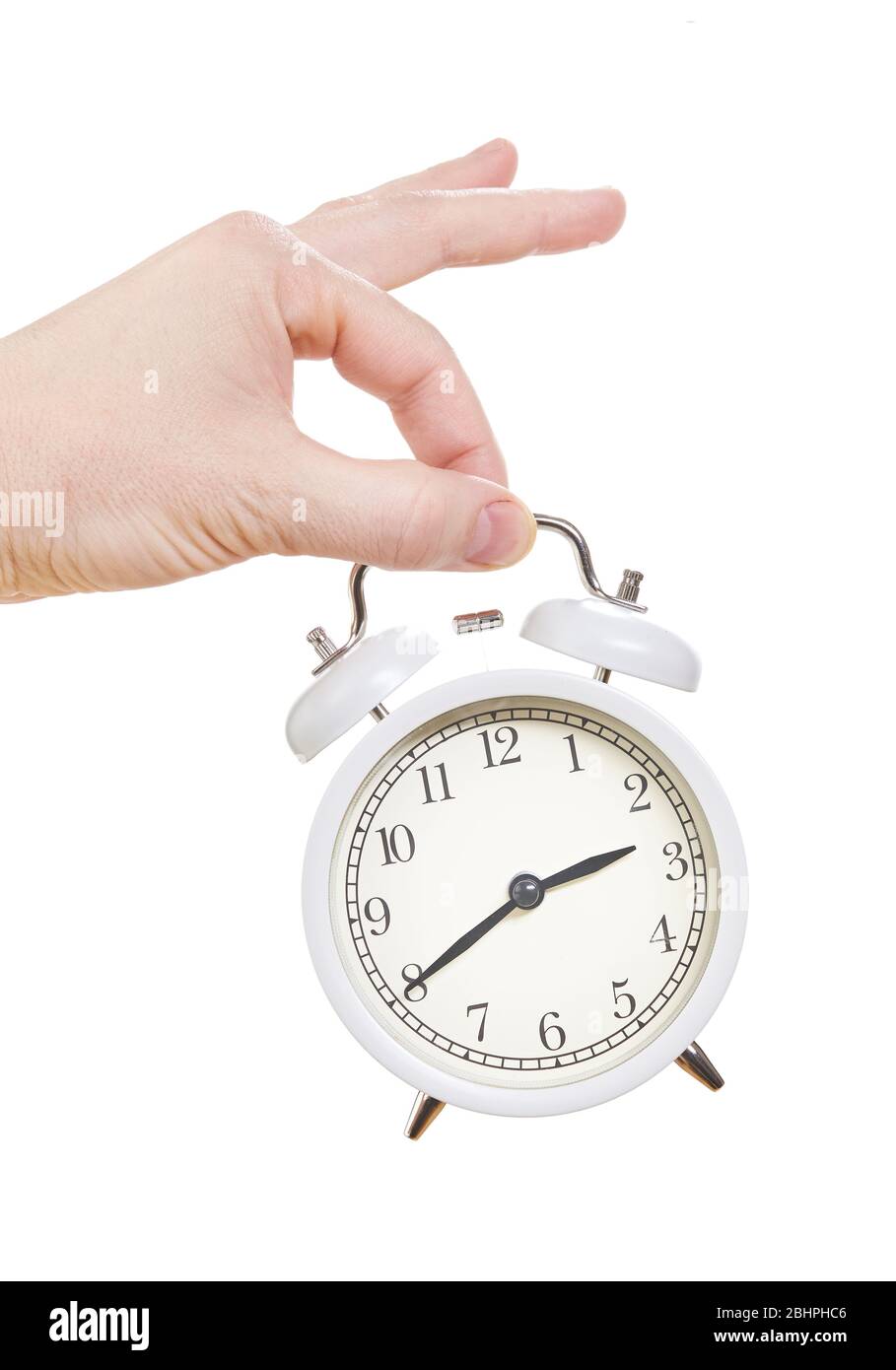 Hand with an alarm clock in a hand. Isolated on white background. Close ...