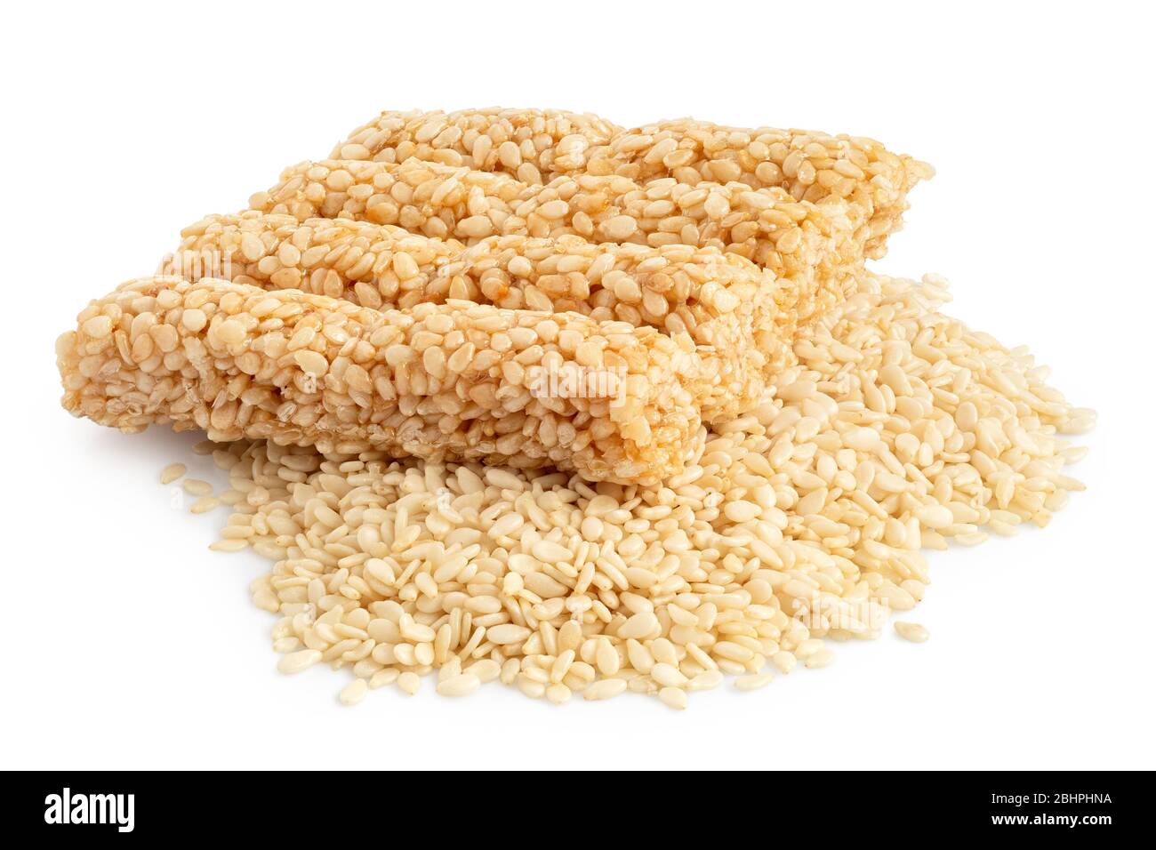 Square sesame seed honey bar on a pile of peeled sesame seeds isolated ...