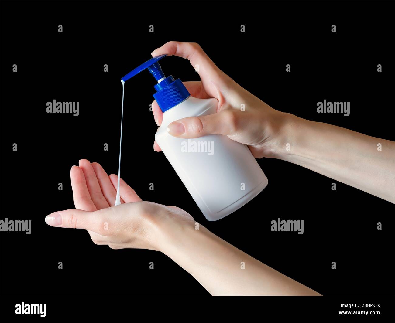 Woman hands pushing soap dispenser with soap drop. Isolated on black ...