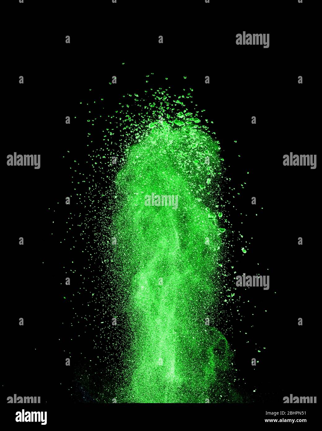 Vertical green powder splash or explosion on a black background Stock ...