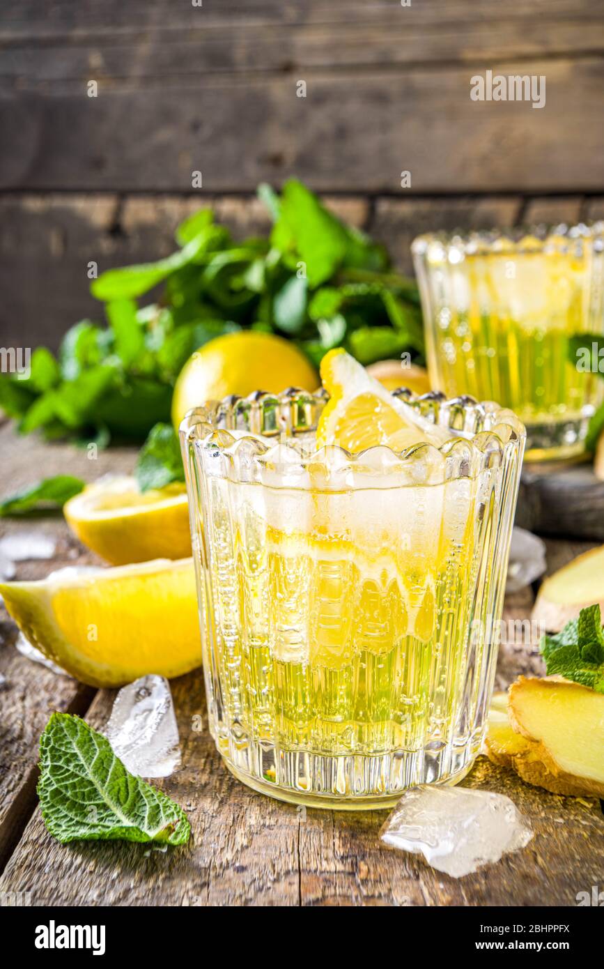 Homemade ginger lemonade cocktail. Cold summer ginger lemon ale. Sweet ...